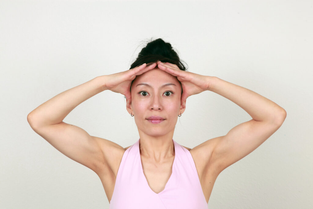 Reduce Frown Lines With This Face Yoga Method Pose